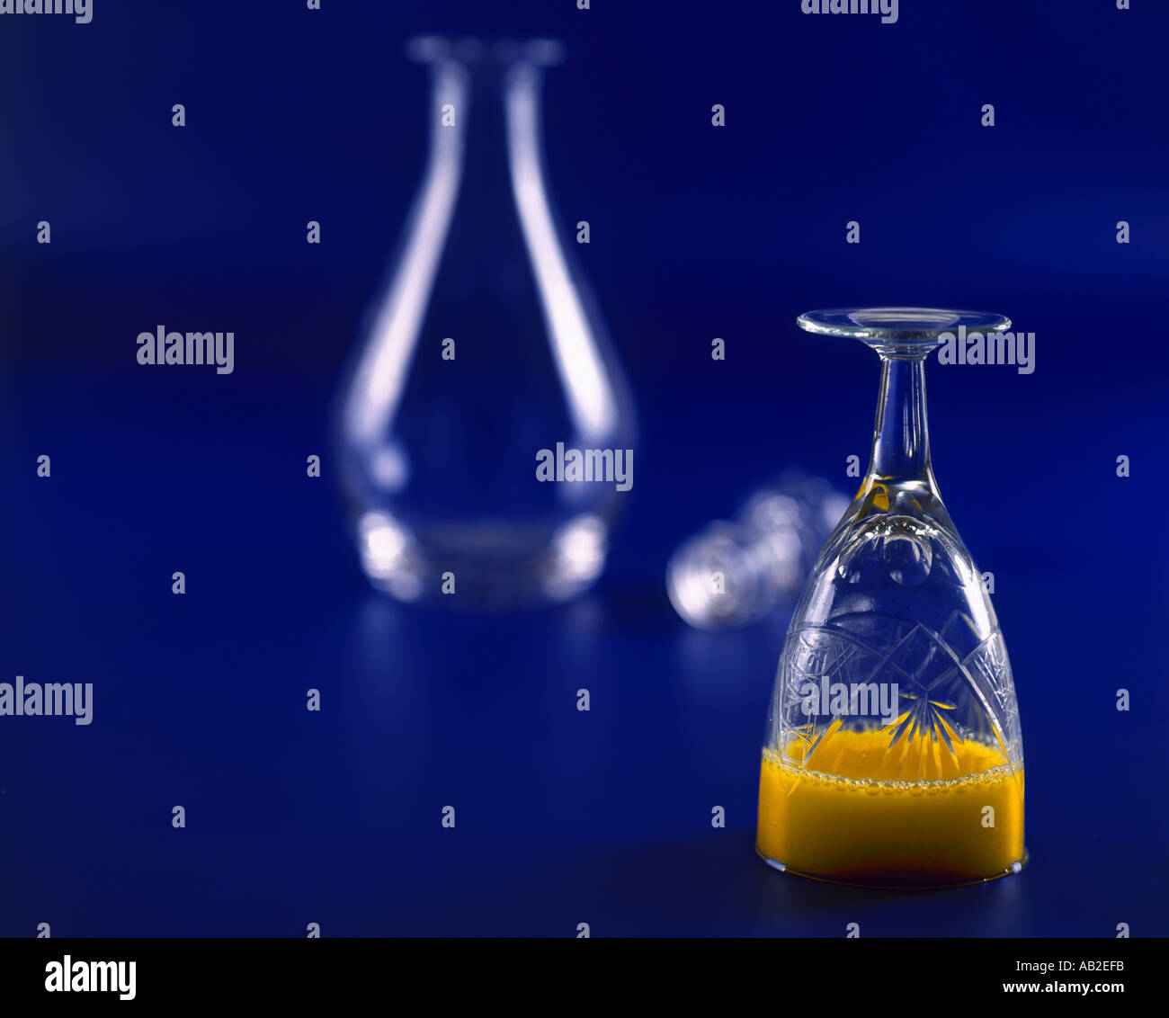 Half empty or half full? Empty carafe and a wineglass bottom up, half ...