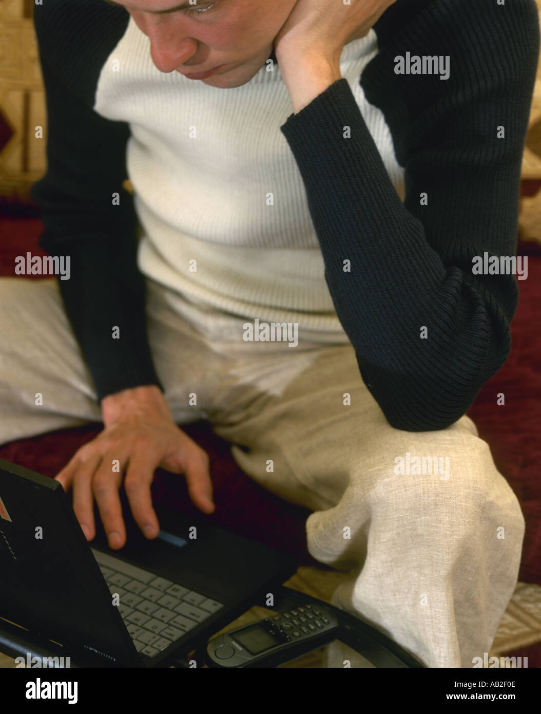 Man sitting concentrated with laptop computer and thinking Stock Photo ...