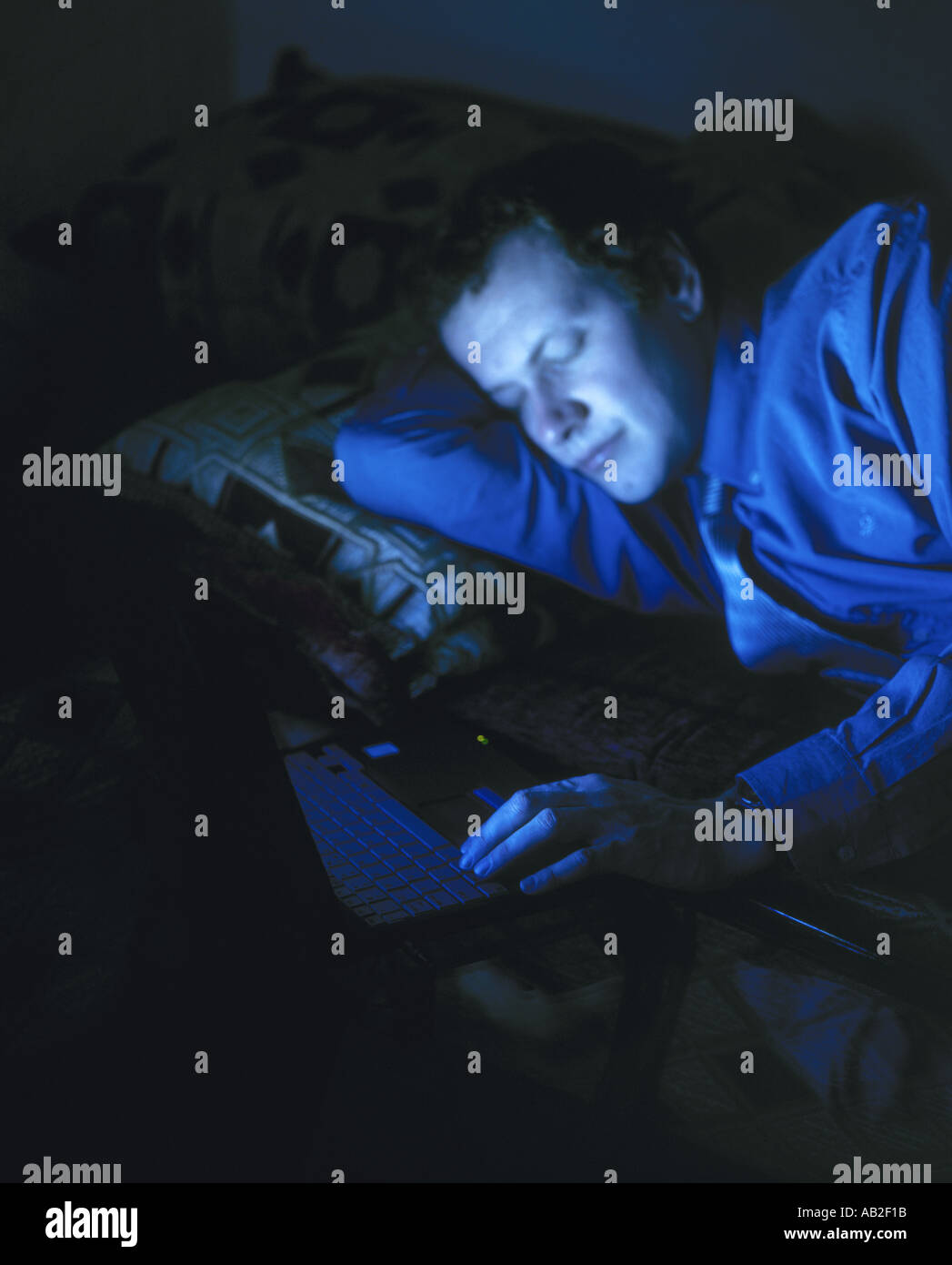 Sleeping man with laptop computer Stock Photo - Alamy