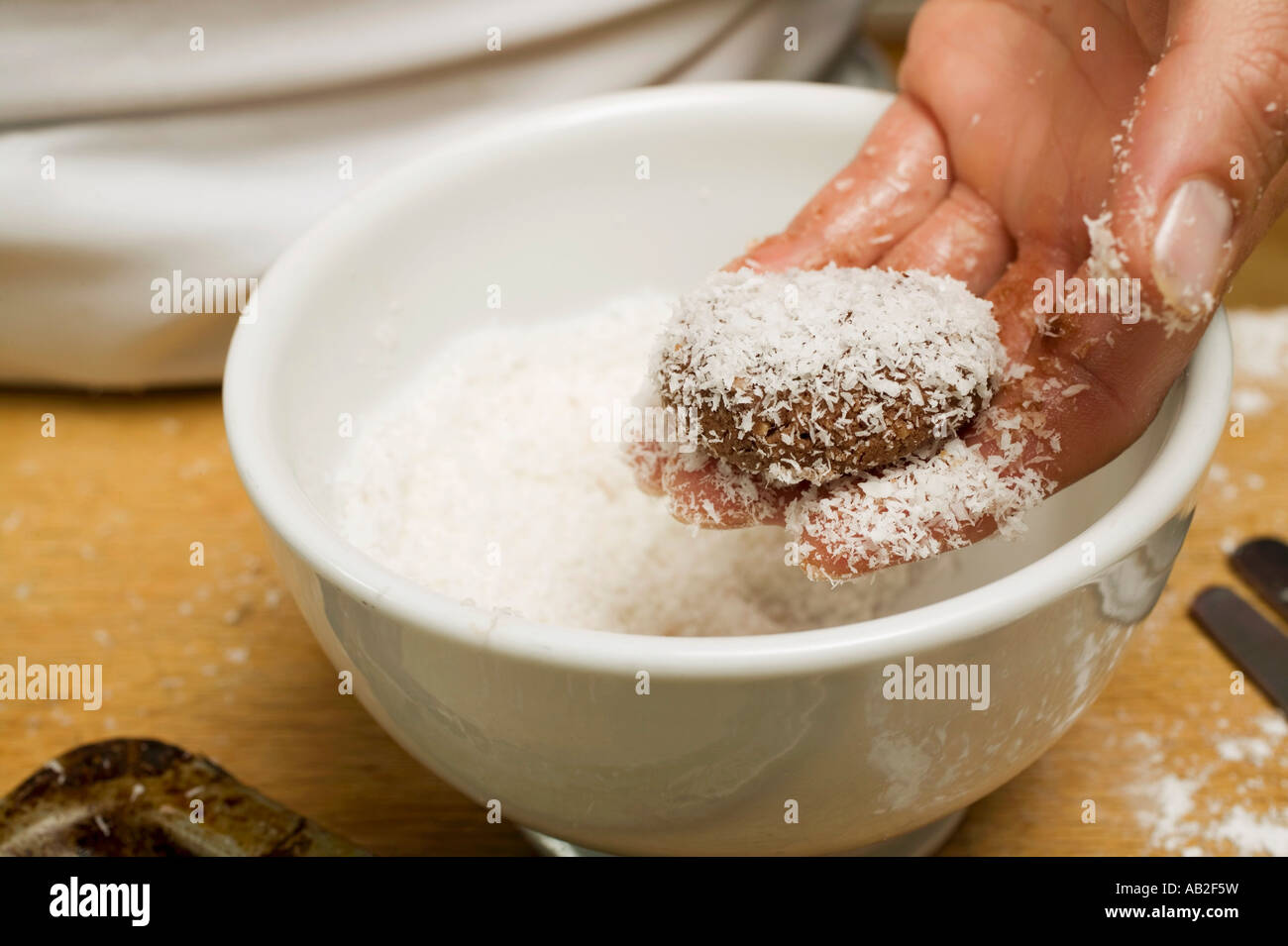 Coating a biscuit in grated coconut FoodCollection Stock Photo - Alamy