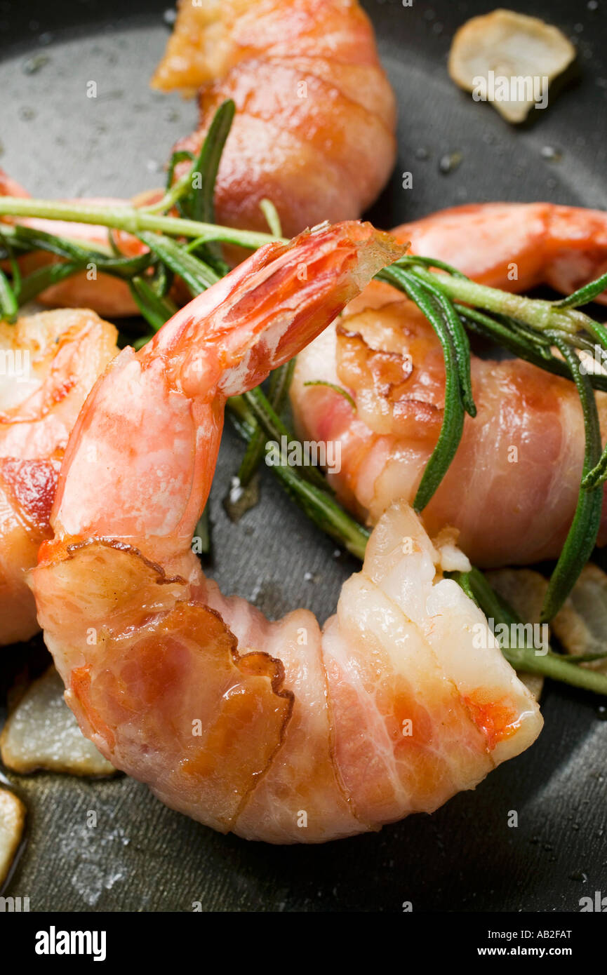 Bacon wrapped king prawns in a frying pan close up FoodCollection Stock ...