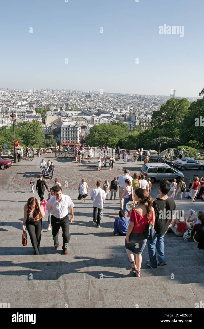 tourist walking down the steps of Sacre Coeur Montmartre in Paris ...