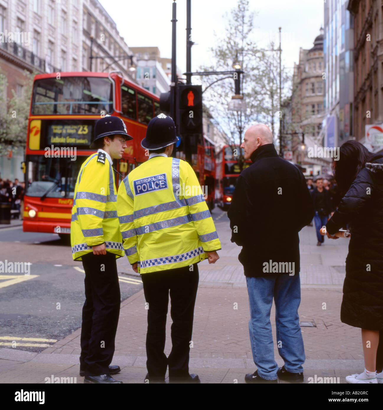 Two London Metropolitan Policemen talking to a member of the public ...