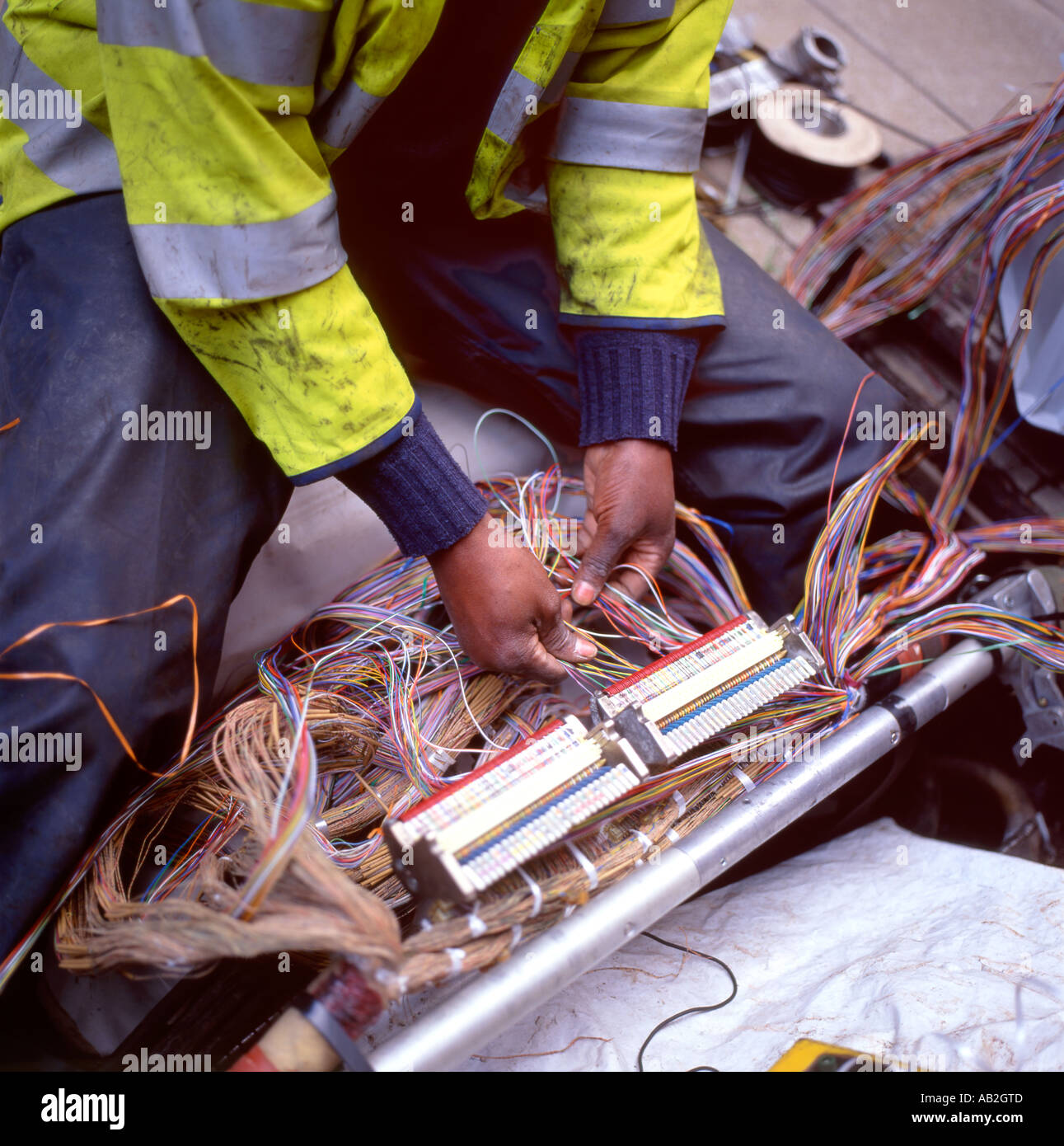 A British Telecom worker employee engineer working with wiring from ... A British Telecom worker employee engineer working with wiring from ...