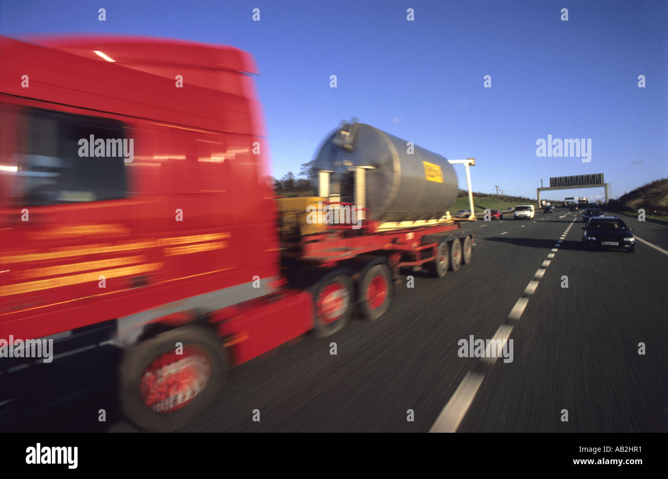 lorry carrying heavy load on trailer travelling on the A1/M1 motorway ...