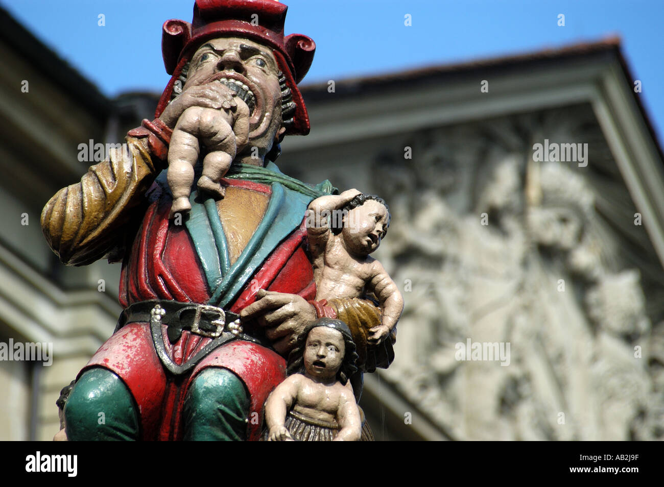 Child eating ogre fountain with architecture of Kornhausplatz Bern ...
