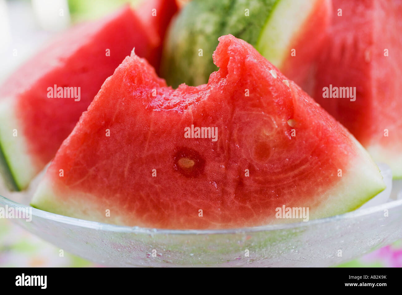 Wedge of watermelon a bite taken in a glass bowl FoodCollection Stock ...