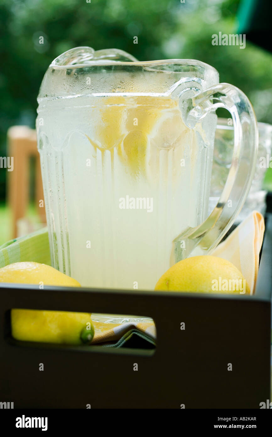 Lemonade in a glass jug with slices of lemon FoodCollection Stock Photo ...
