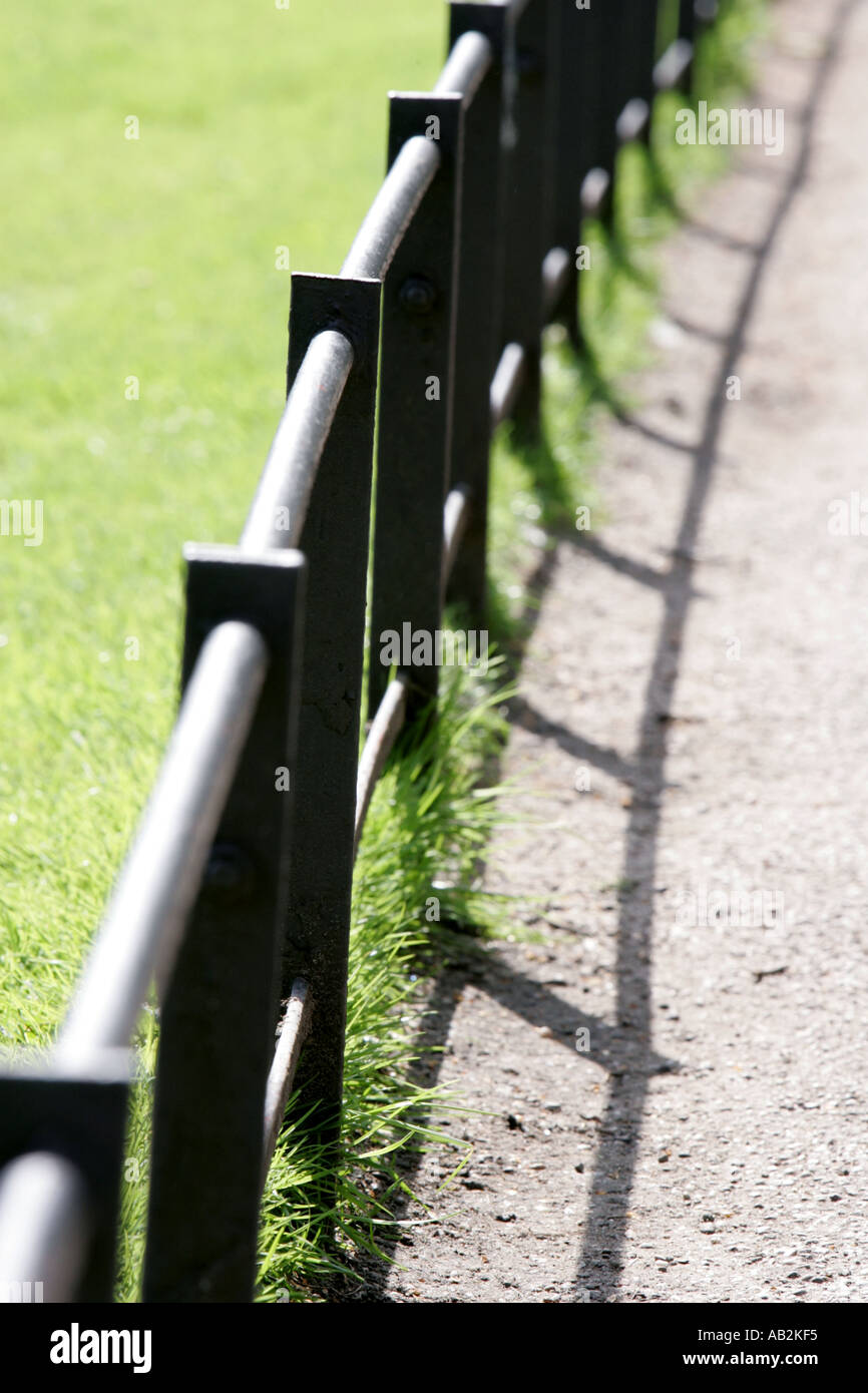 fence black metal short in a park diagonal composition sunny weather ...