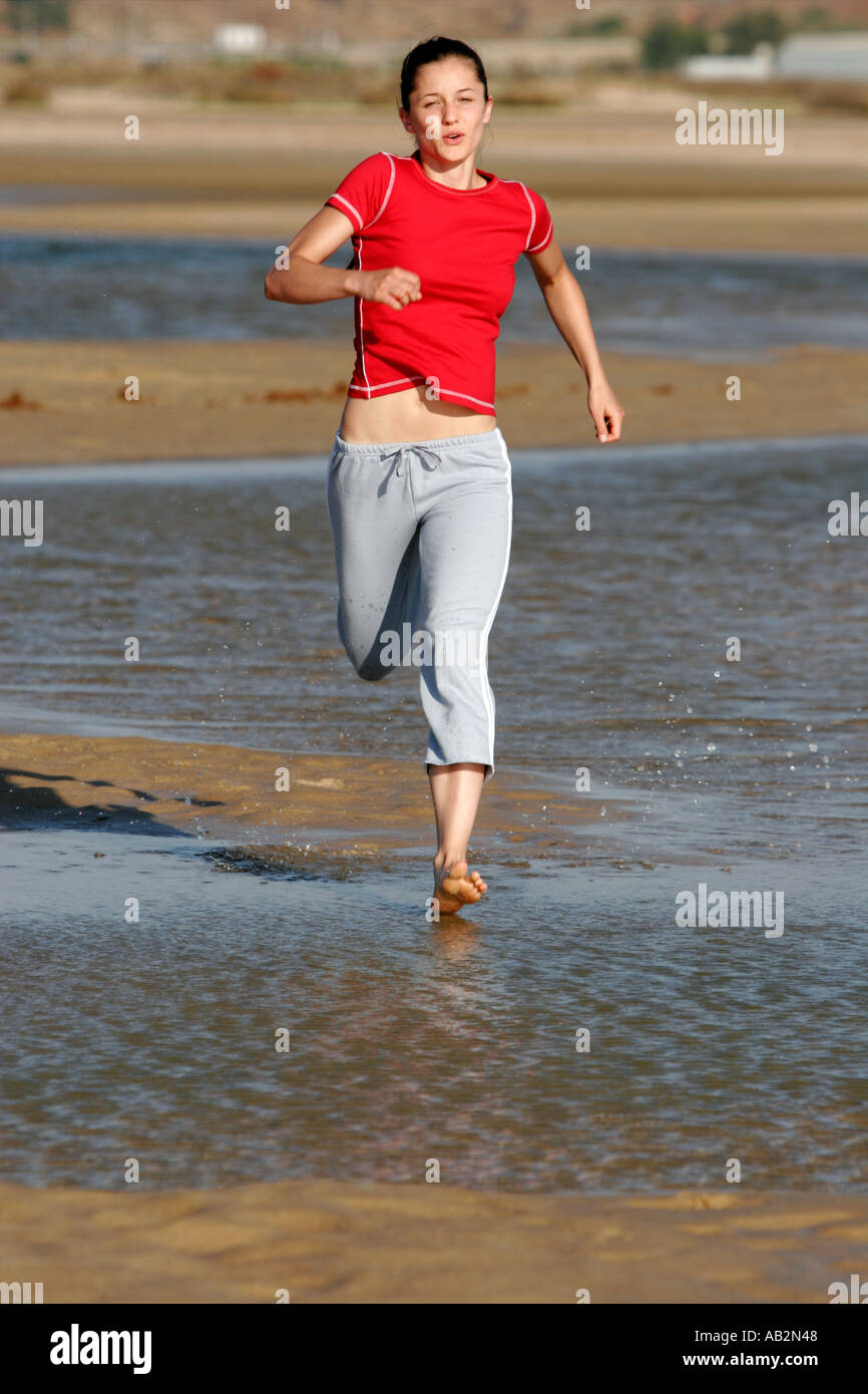 woman running on the beach Stock Photo - Alamy