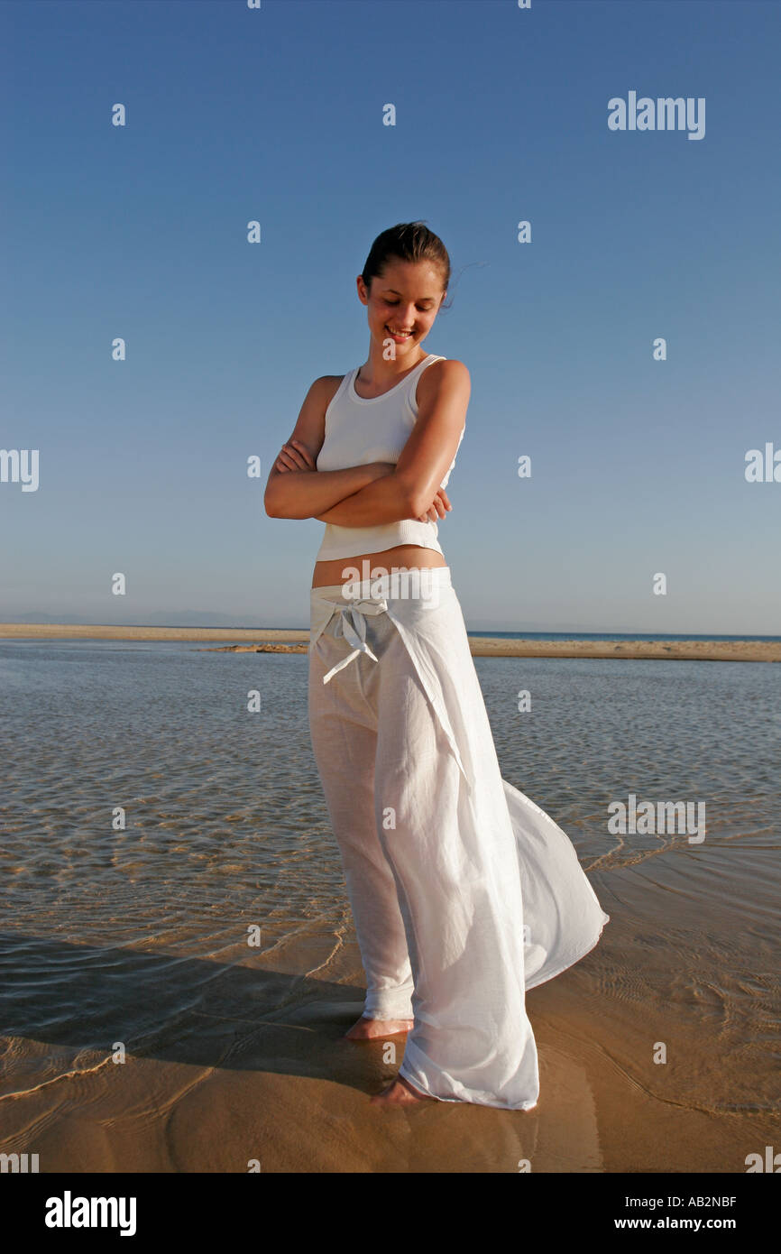 young woman standing in water looking down smiling Stock Photo - Alamy