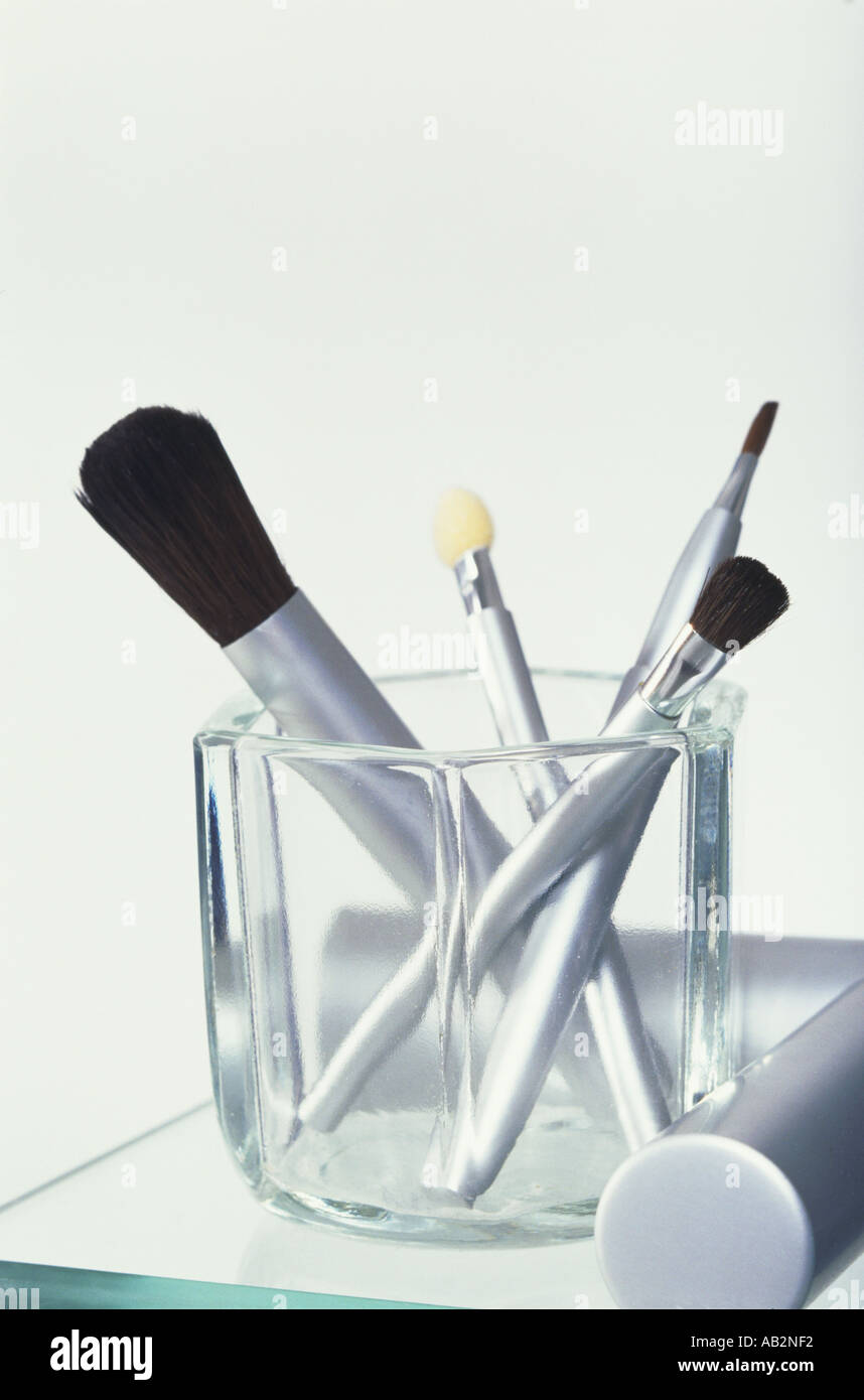 Make up brushes in a glass container Stock Photo - Alamy