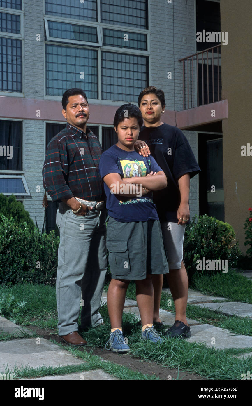 A Mexican family poses in front of their apartment in a low cost ...