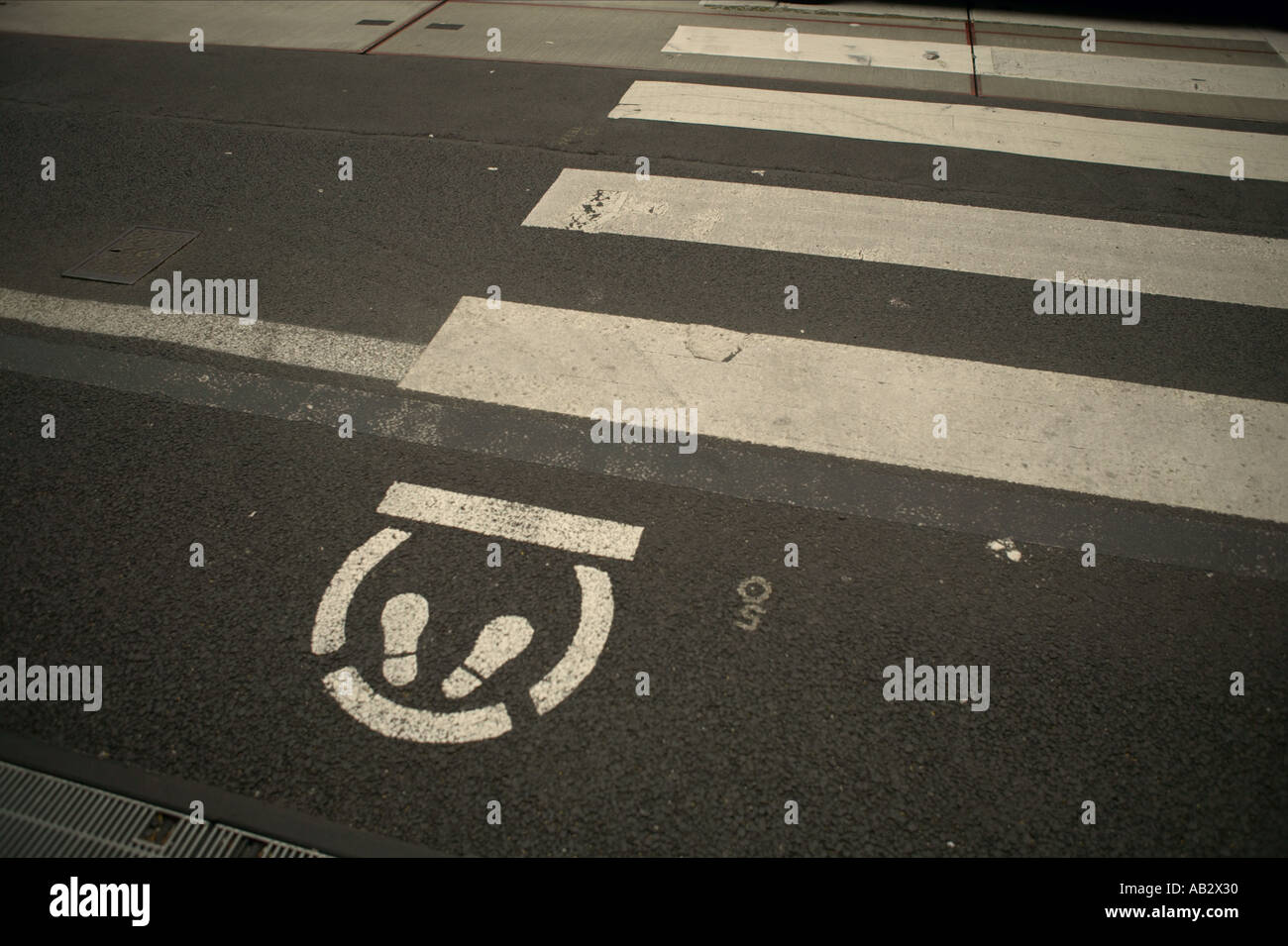 Feet and crossing sign Stock Photo - Alamy