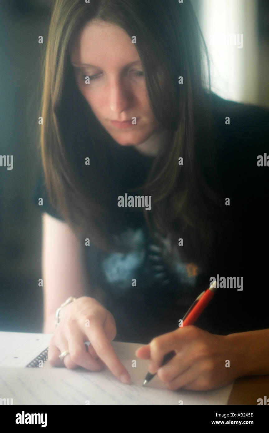 Writing A young left handed woman writing Stock Photo - Alamy