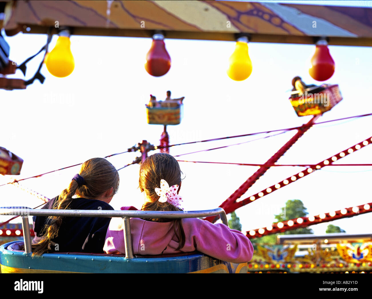 sisters on a funfair ride Stock Photo - Alamy
