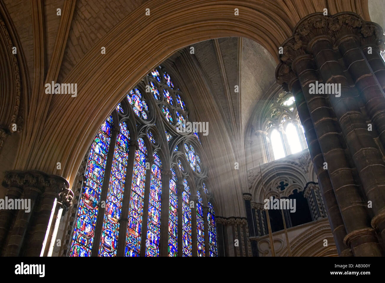 Light streams through stain glass windows of a church Lincoln Cathedral ...