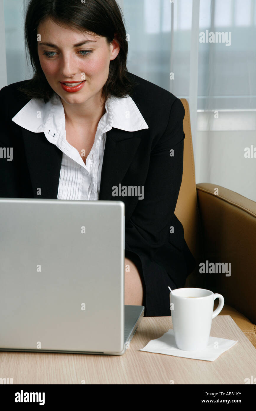 Successful business woman focused on her work using a laptop Stock ...