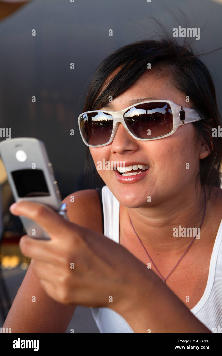 Young woman using cell phone Stock Photo - Alamy
