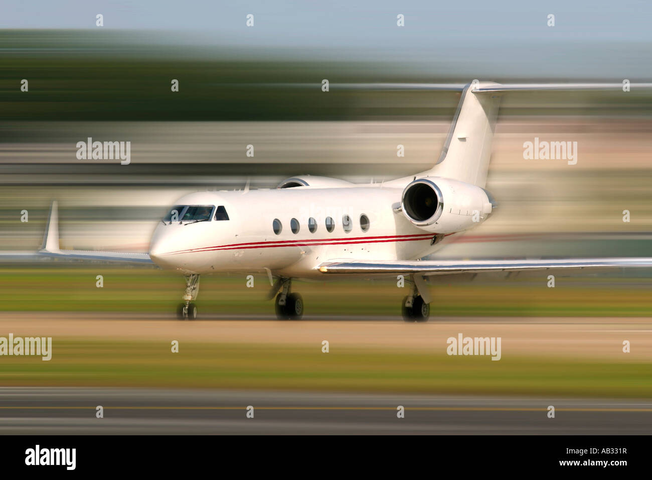 Corporate jet prepareing for departure at an airport with motion blur ...