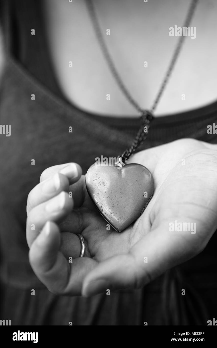 Hand holding heart shaped locket Stock Photo - Alamy