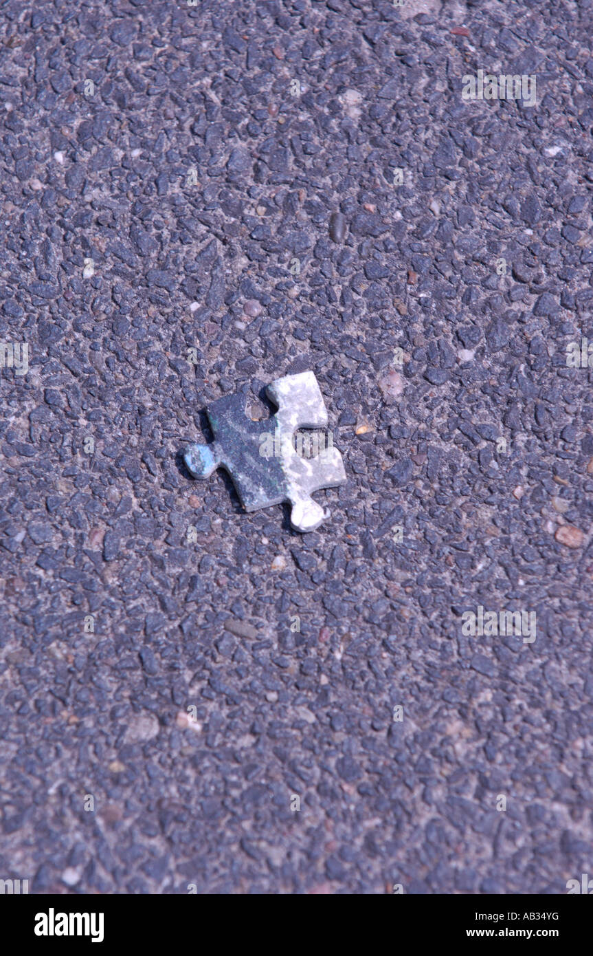 jigsaw piece puzzle floor ground tarmac one single lost Stock Photo - Alamy