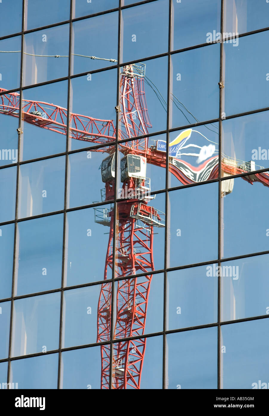 A red crane reflected in the windows of an office block in the centre ...