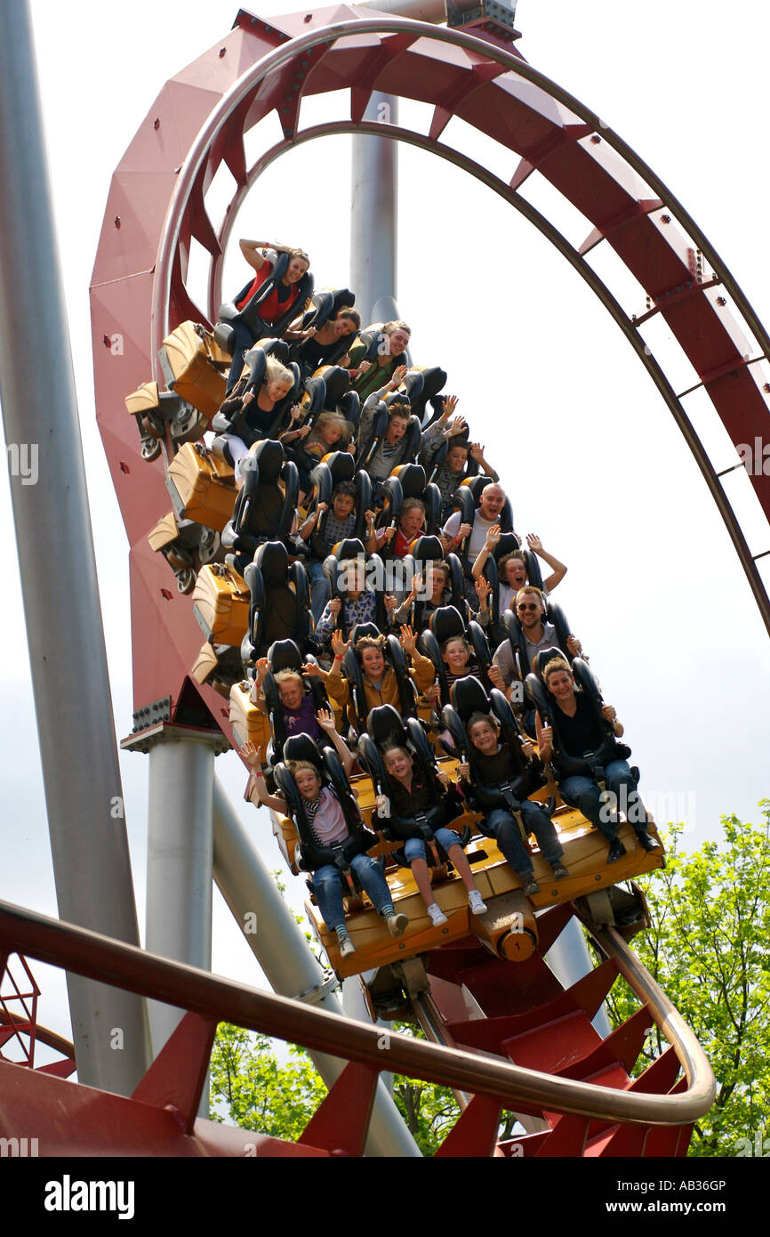 People riding a roller coaster at the Tivoli Gardens amusement park in ...
