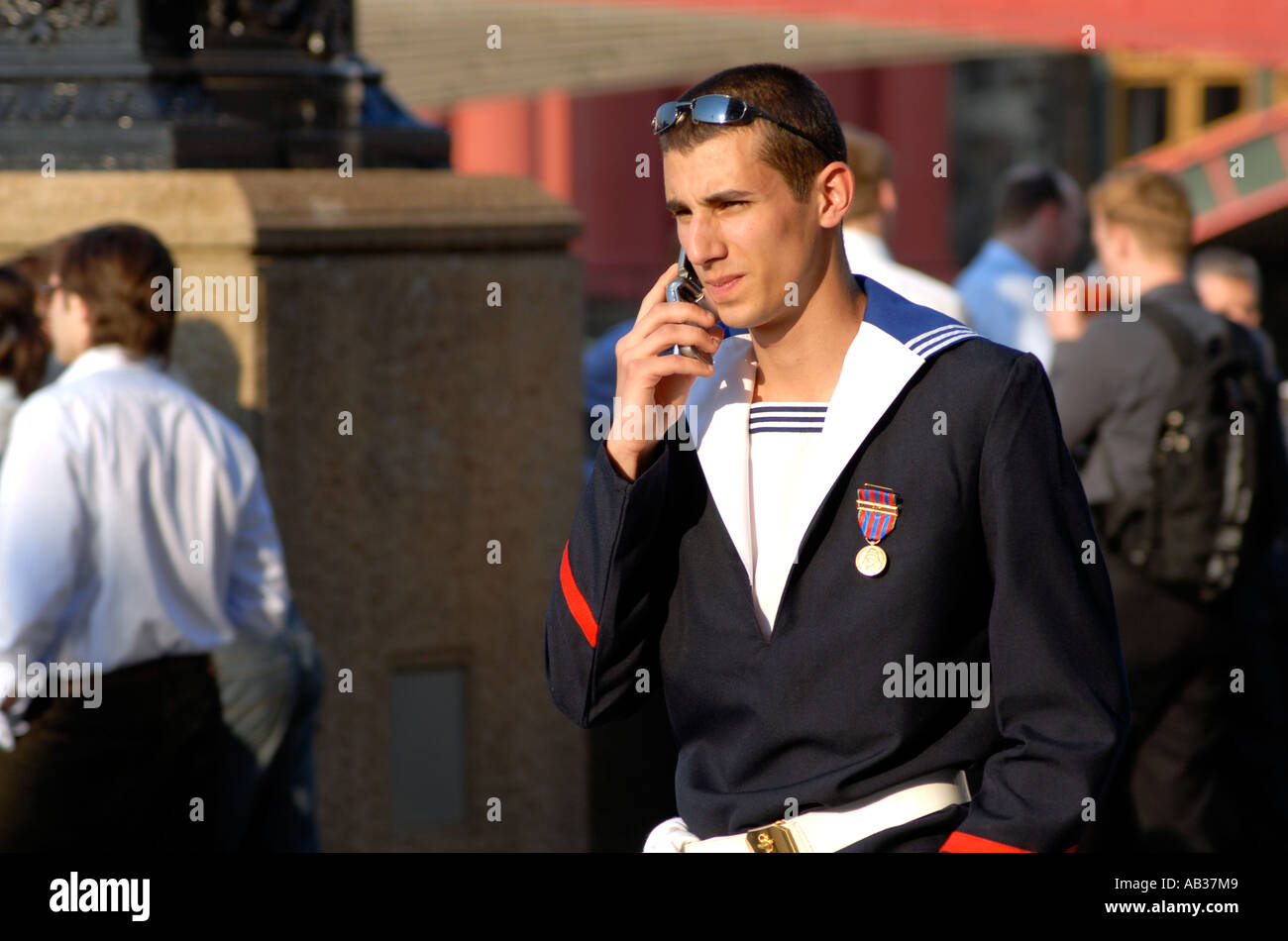 Sailor using a mobile phone on the South Bank by the River Thames ...