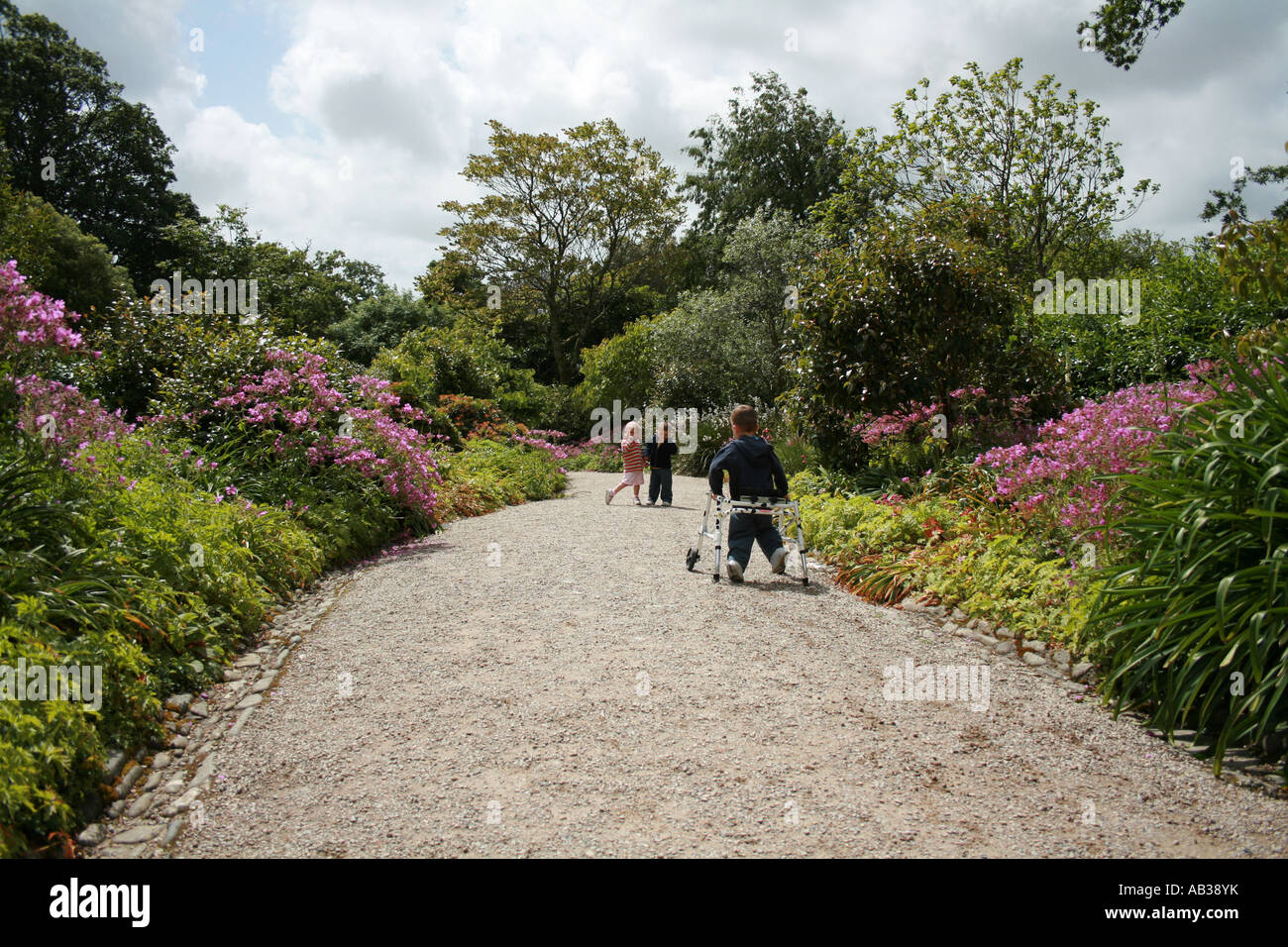 Disabled child in Kaye walker walking towards two children Stock Photo ...
