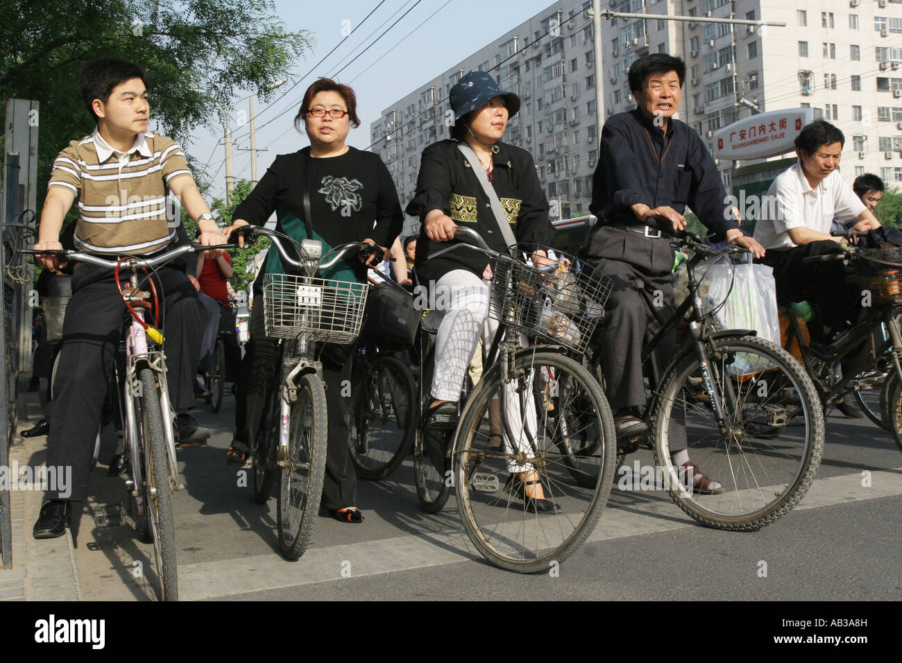 Cyclists stop at traffic lights on intersection in Beijing, China Stock ...