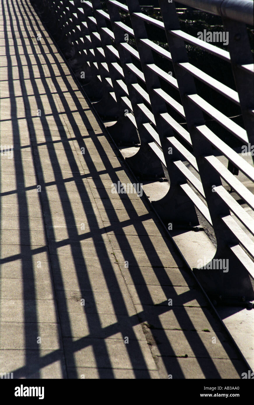 The shadow of railings throw a pattern on the pavement Stock Photo - Alamy