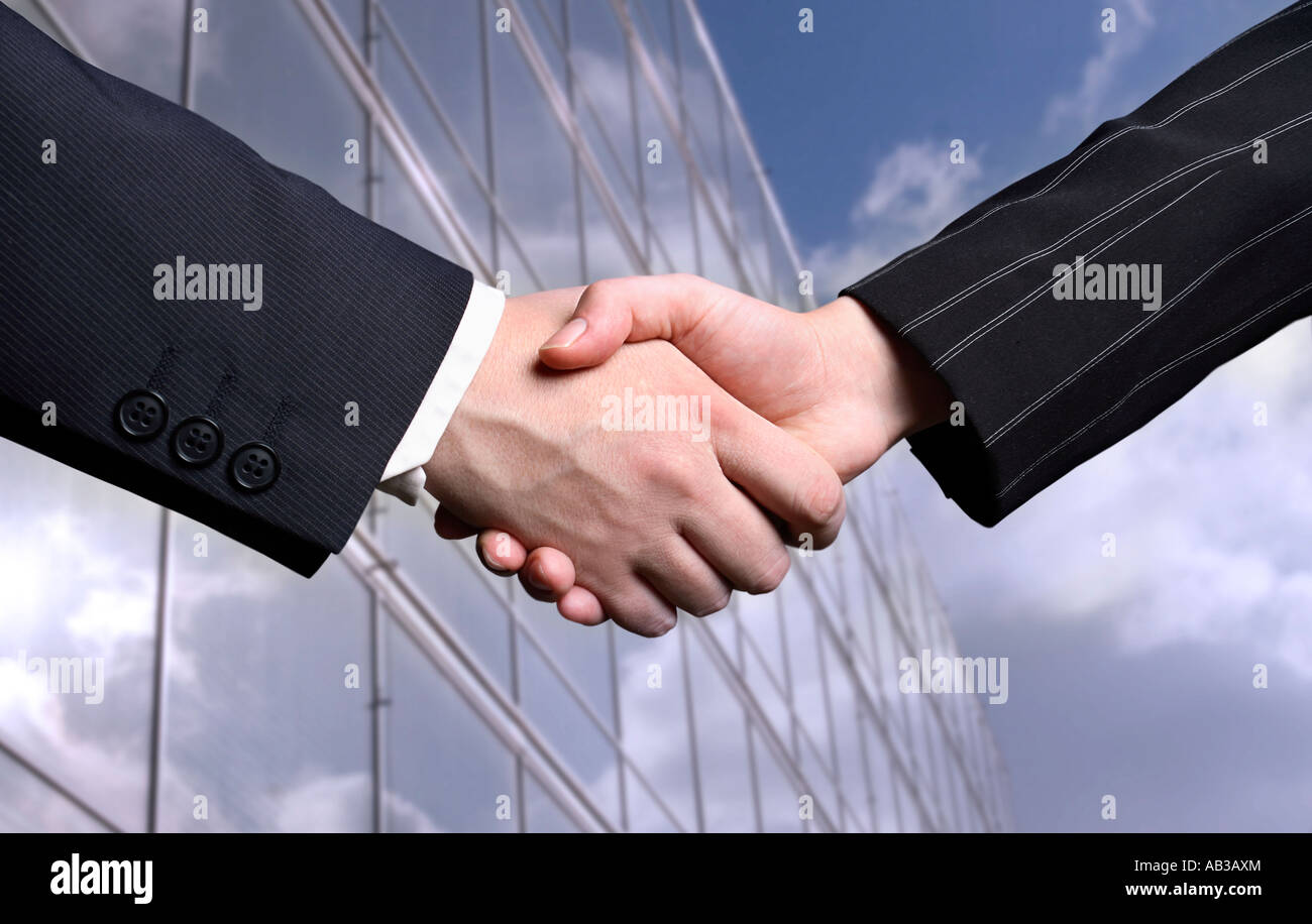 Hand shake with buildings hi-res stock photography and images - Alamy