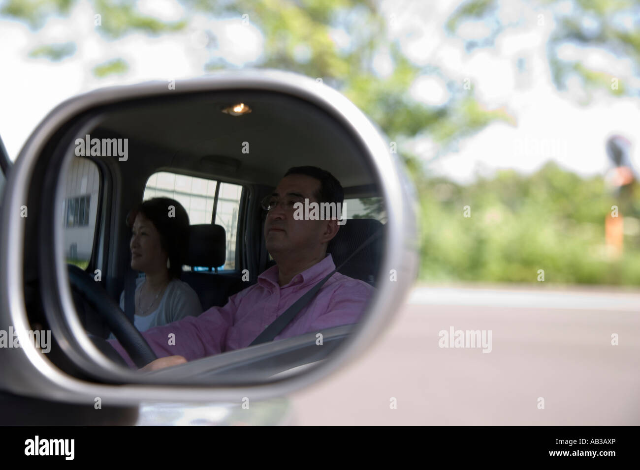 Mature couple reflected on side view mirror Stock Photo - Alamy