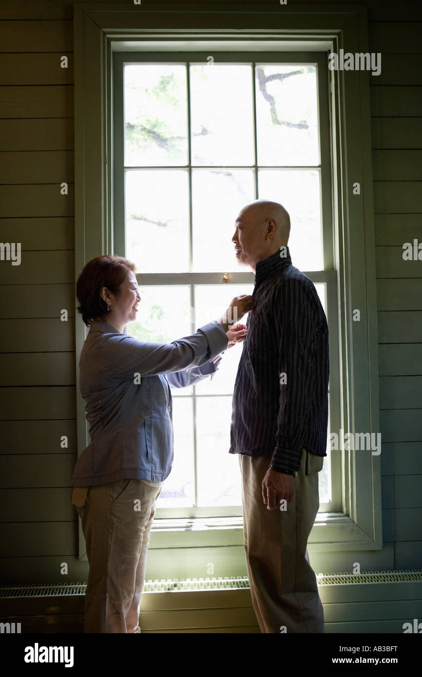 Woman adjusting shirt collar hi-res stock photography and images - Alamy