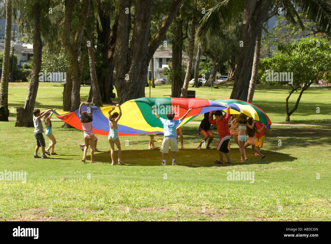 Children playing with "eskimo blanket", Kailua, Oahu, Hawaii Stock ...