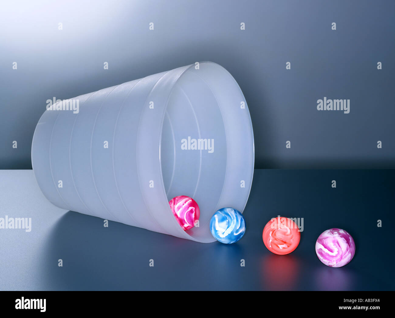 Waste bin on its Side with Swirly Coloured Balls Stock Photo - Alamy