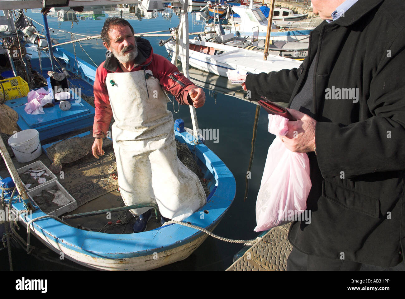 Fisherman selling his early catch Stock Photo - Alamy