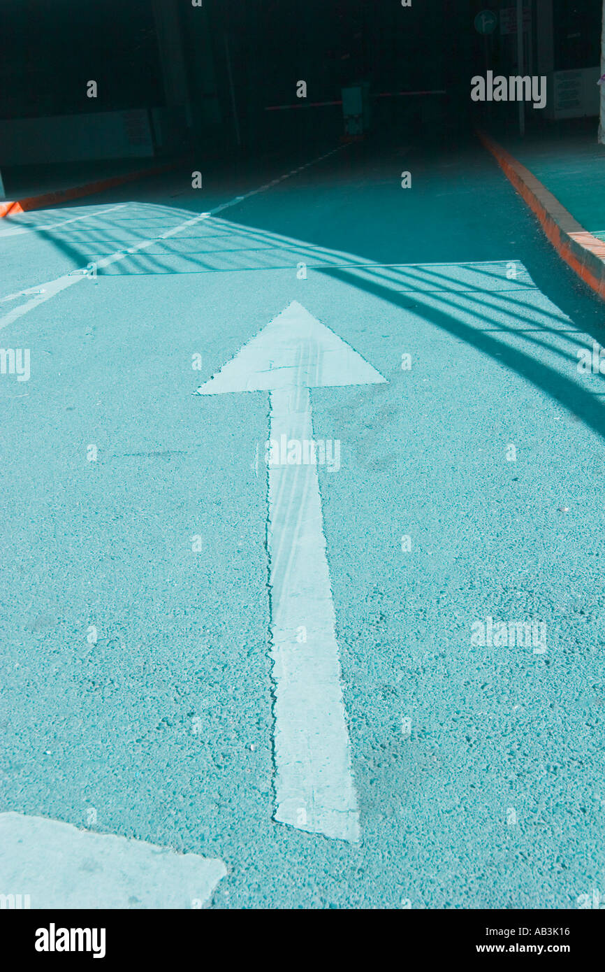 Arrow signalling direction into underground parking garage Stock Photo ...
