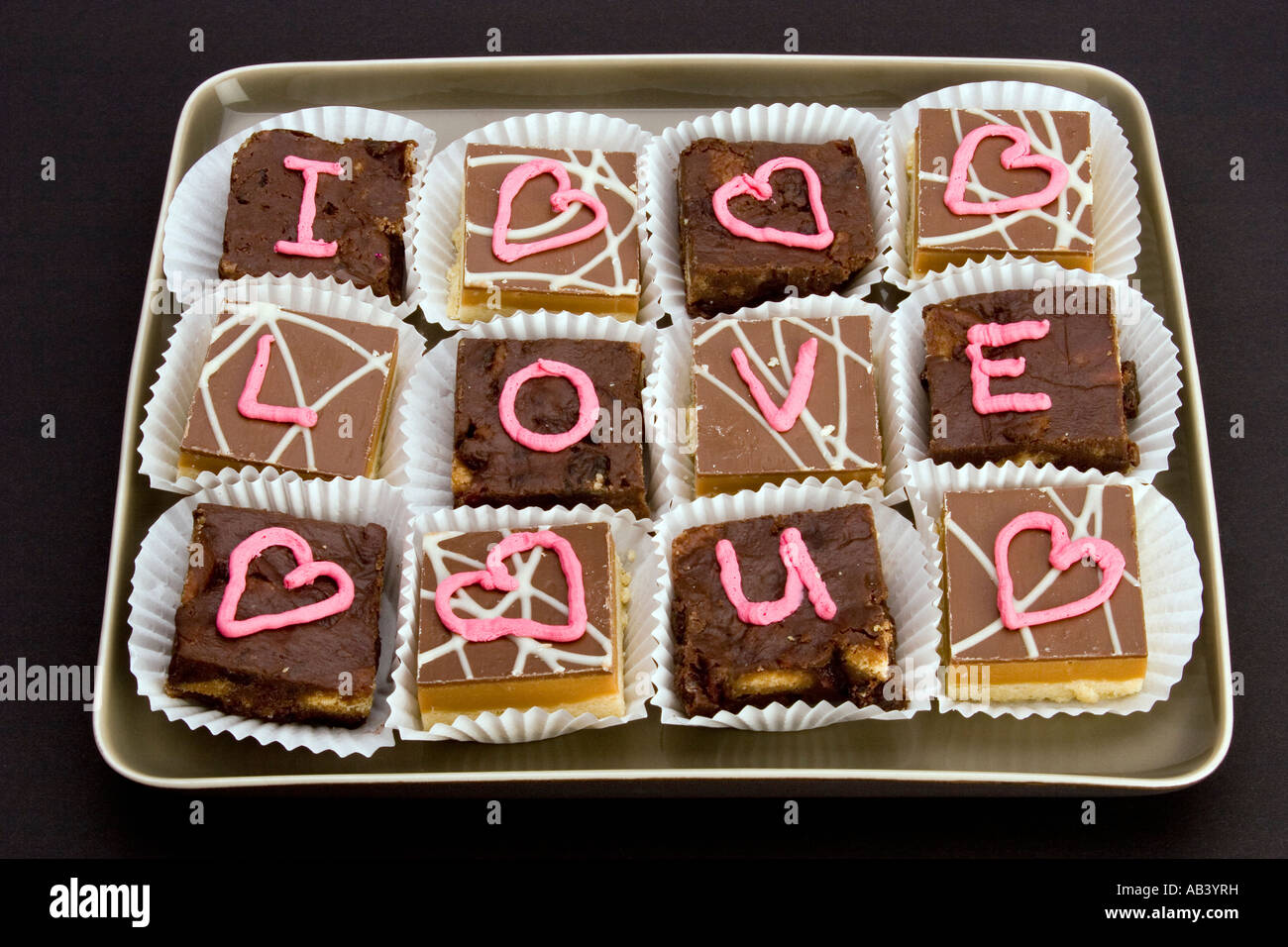 Chocolate cakes with 'I love you' and 'love hearts' written in icing ...
