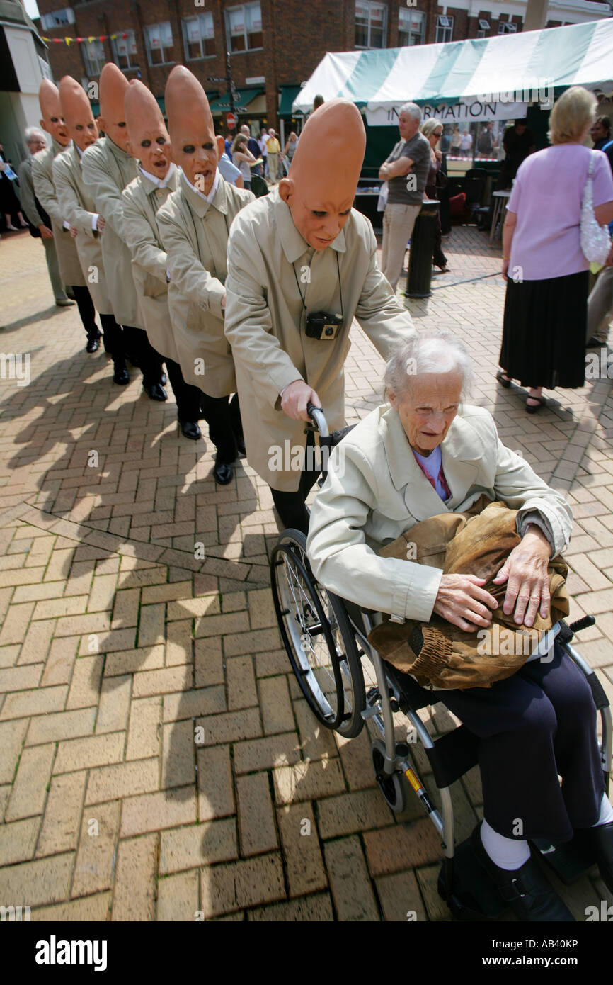 Street performers The Coneheads with elderly woman in wheelchair ...