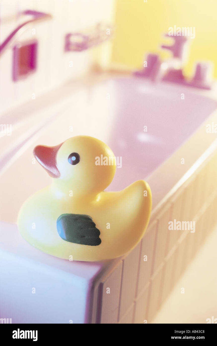 Rubber Duck Sitting on Edge of Bathtub Stock Photo - Alamy