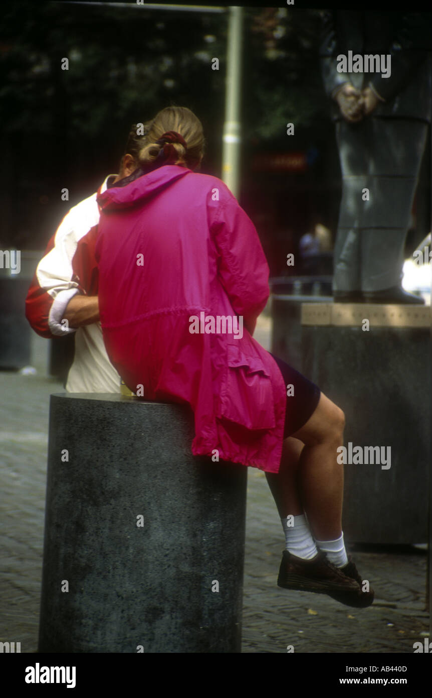 Back view of girl in red coat sitting Stock Photo - Alamy