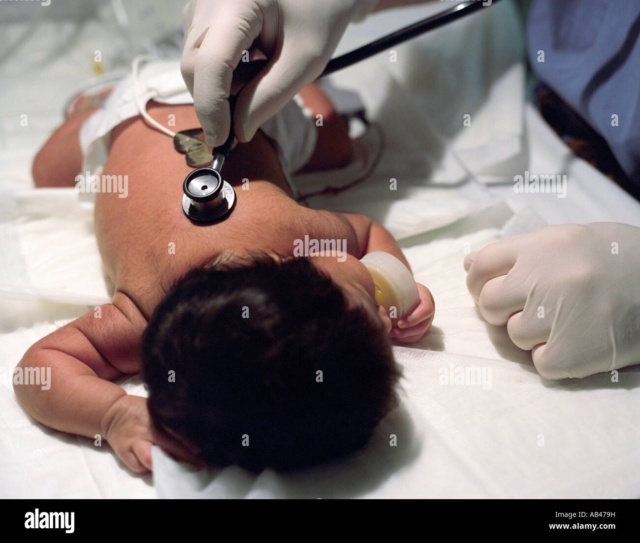 A doctor cares uses a stethoscope and listens to the heart for a ...