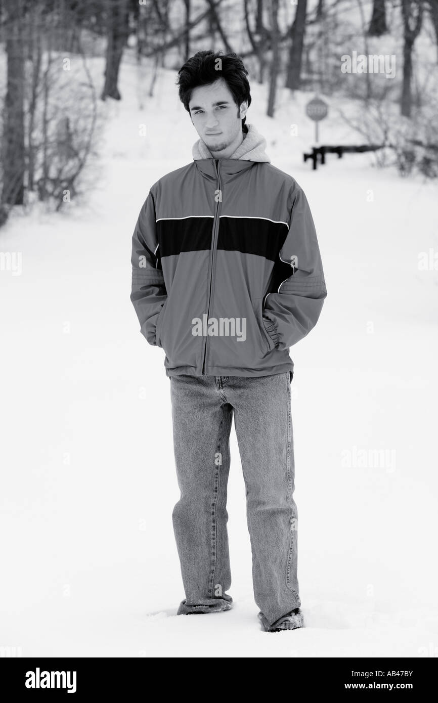 A young man poses while standing in snow Stock Photo - Alamy
