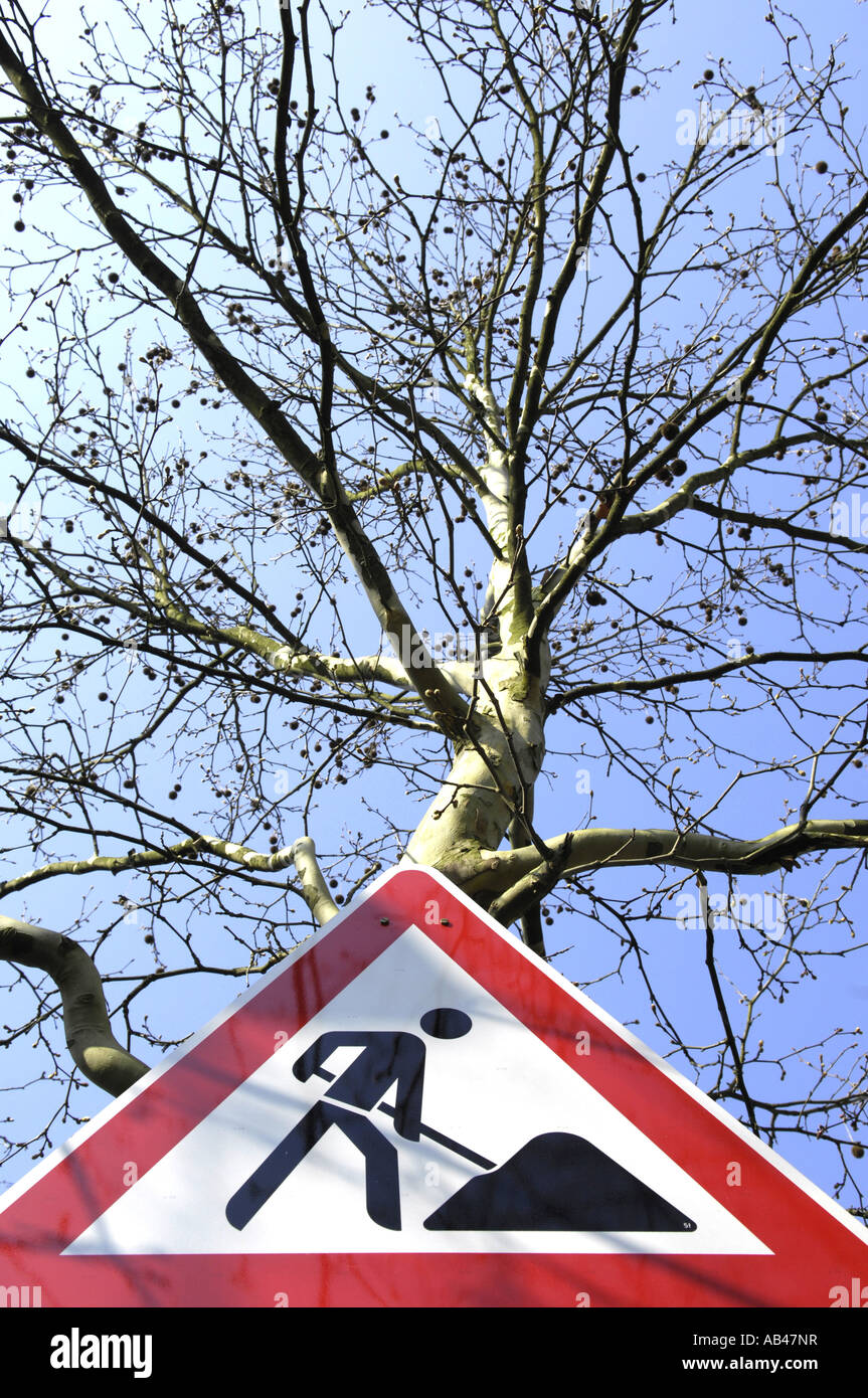 workman tree branches vertical winter work in progress red white black ...
