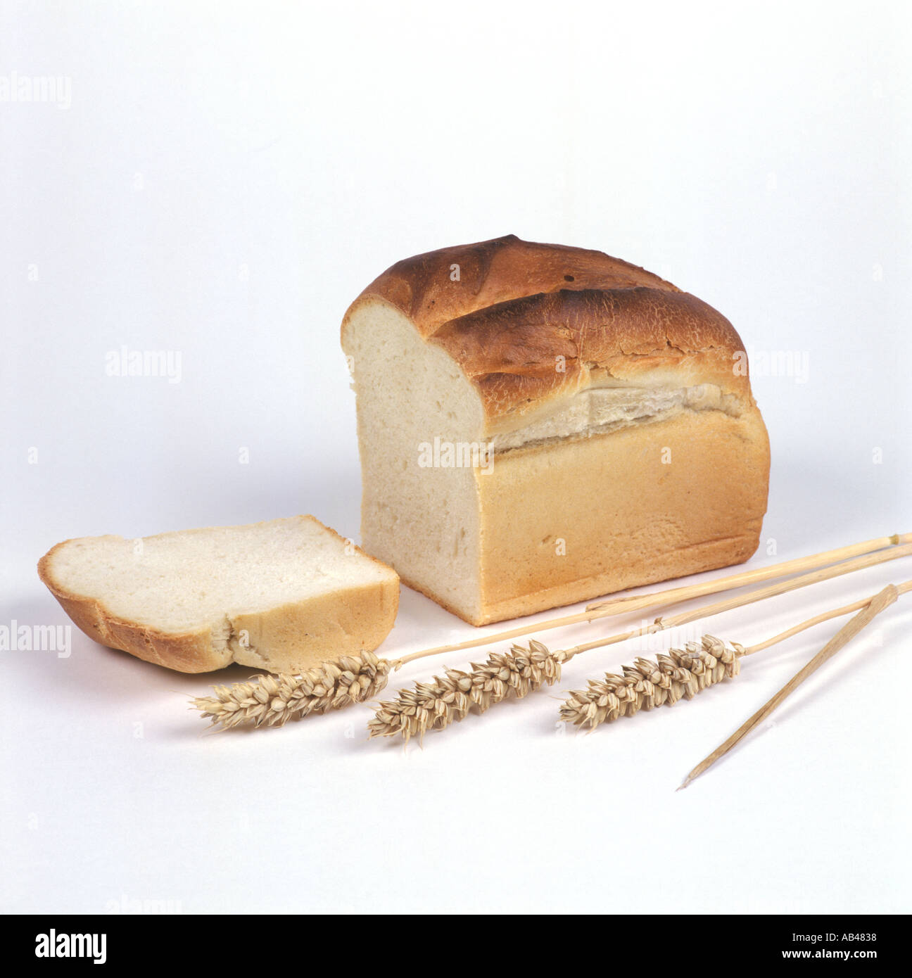 A loaf of white bread with ears of wheat Stock Photo - Alamy