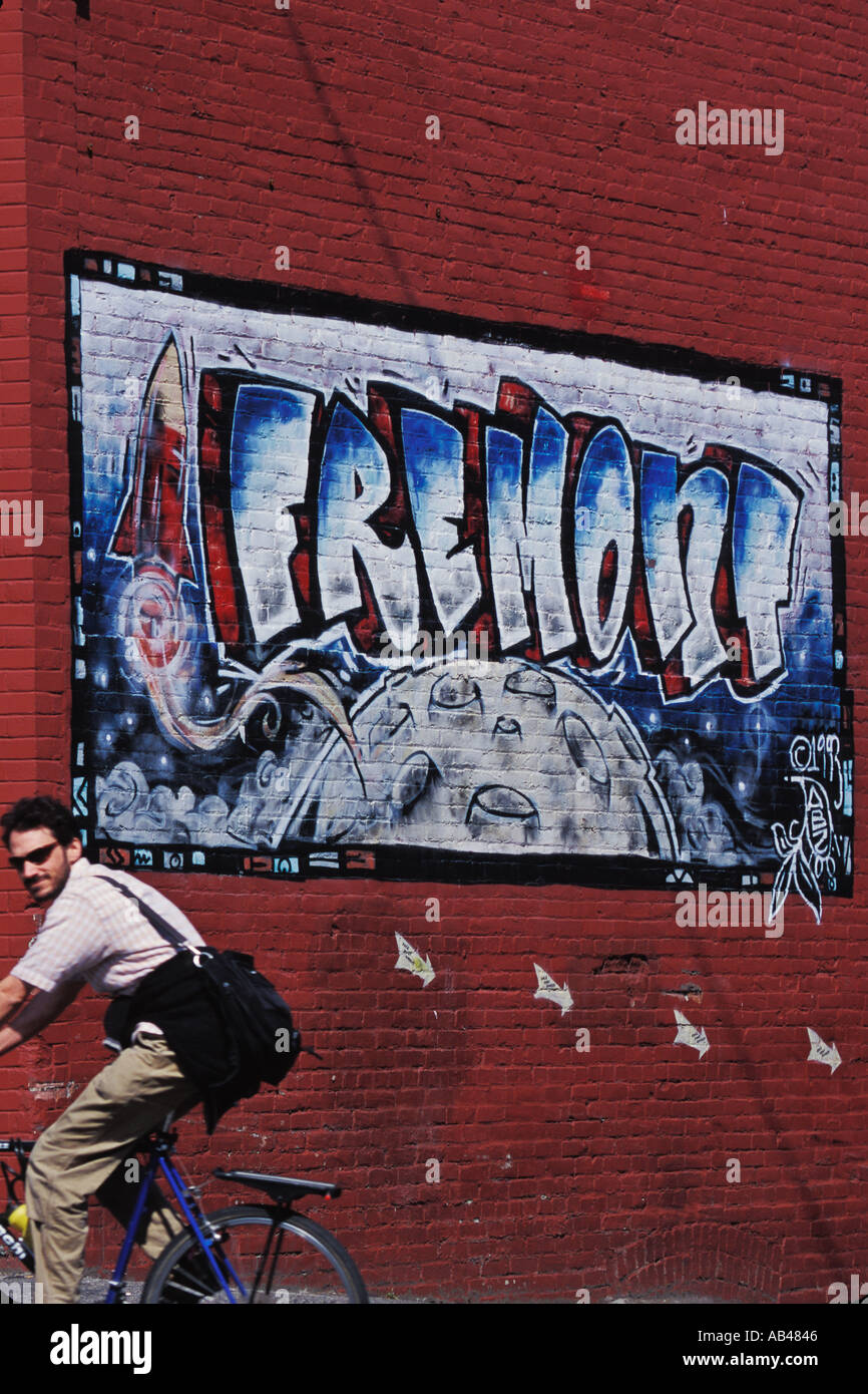 Man on bicycle rides past Fremont sign on building in Fremont District ...