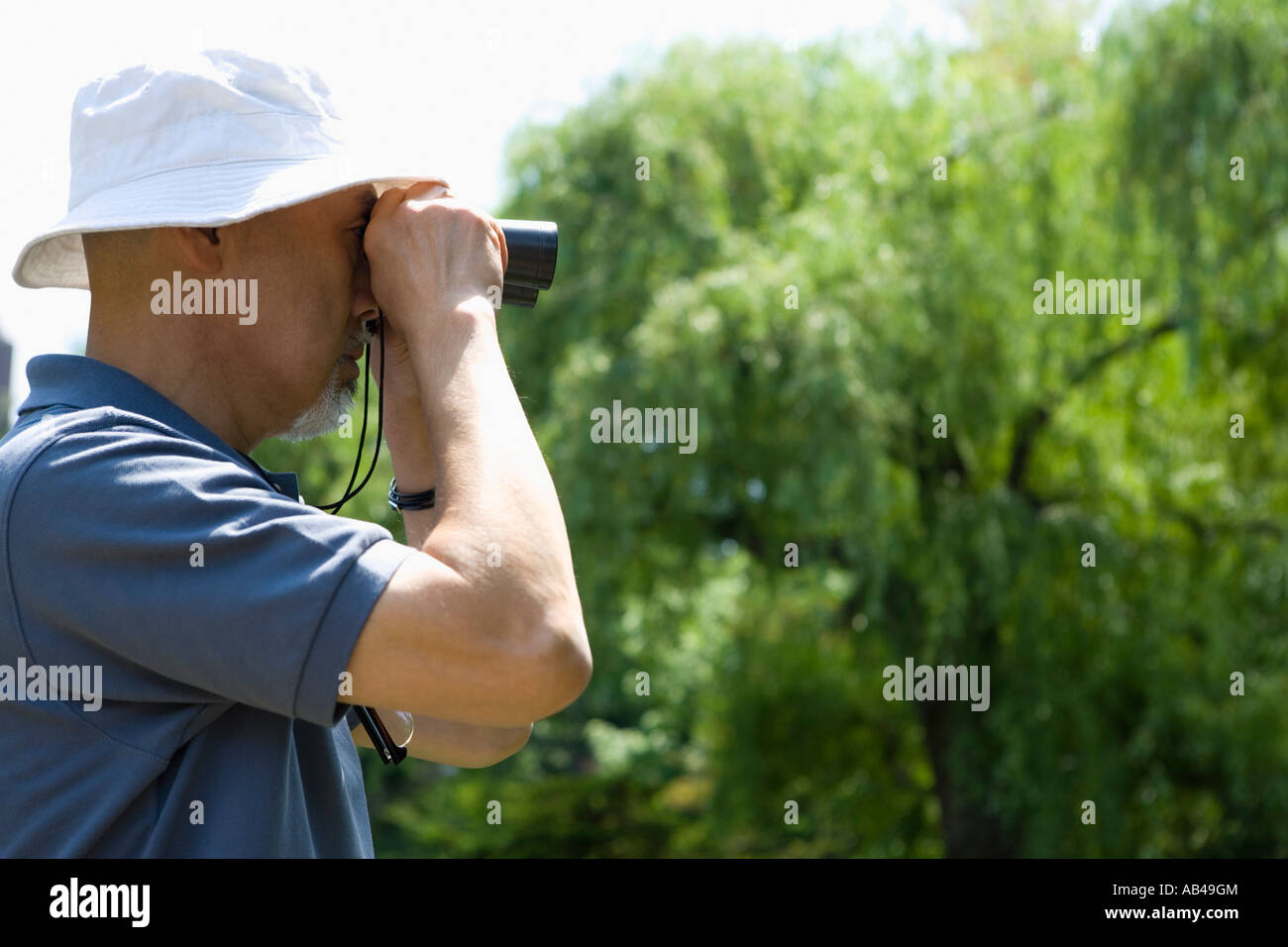 Senior man using binoculars Stock Photo - Alamy