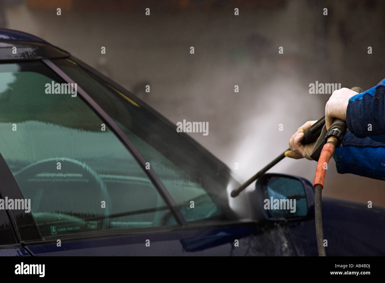 Man washing car with high pressure jet wash Stock Photo - Alamy